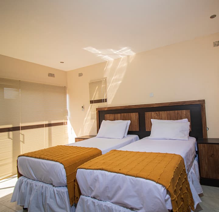 A Bedroom With Ac And A Pool Outside. - Victoria Falls