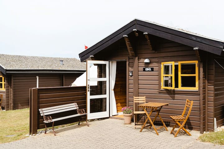 A Small Wooden Hut In A Large Community - Thorsminde